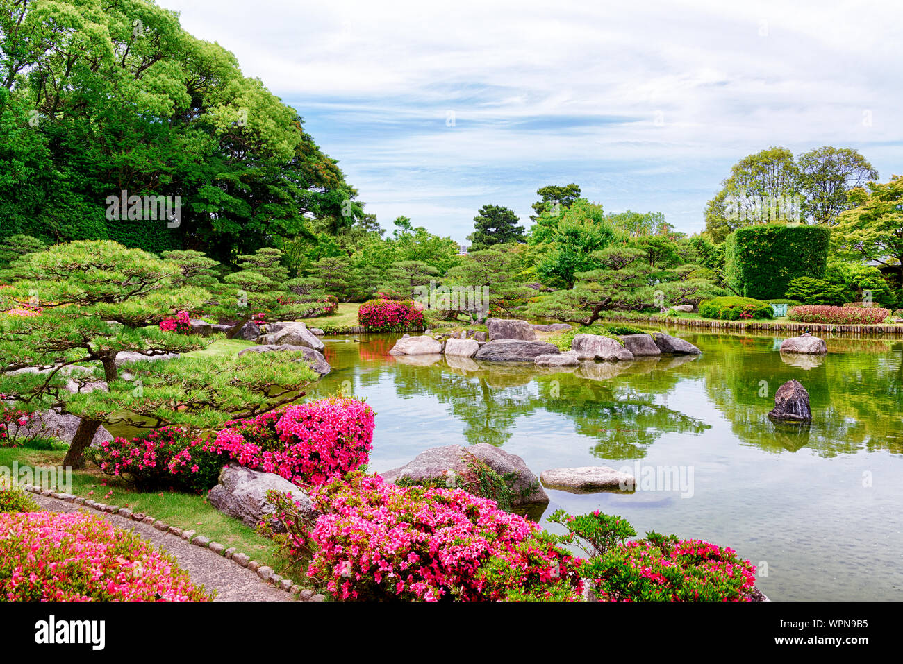 Beautiful lake with island in spring Japanese garden Stock Photo - Alamy