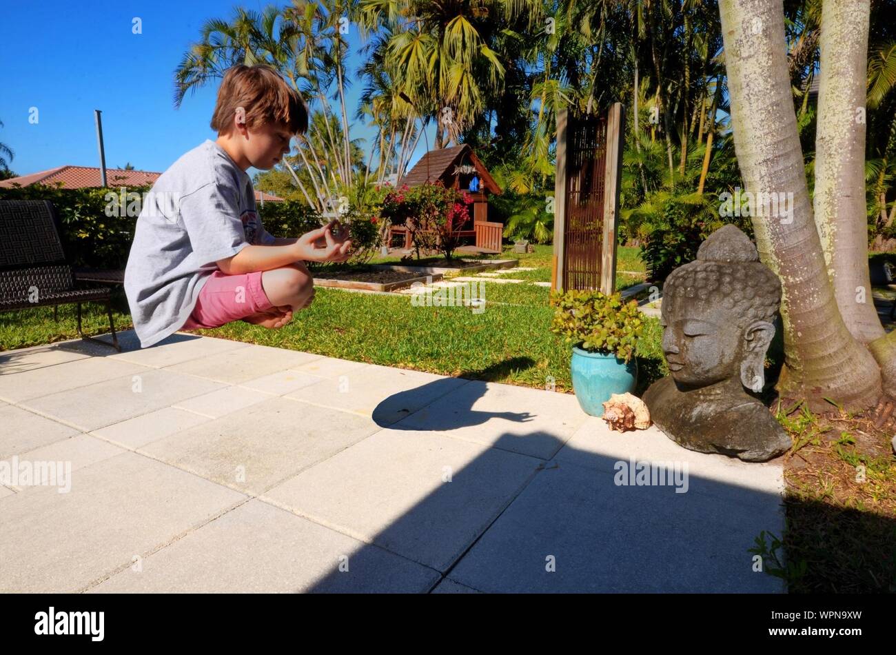 Boy cross legged side view hi-res stock photography and images - Alamy