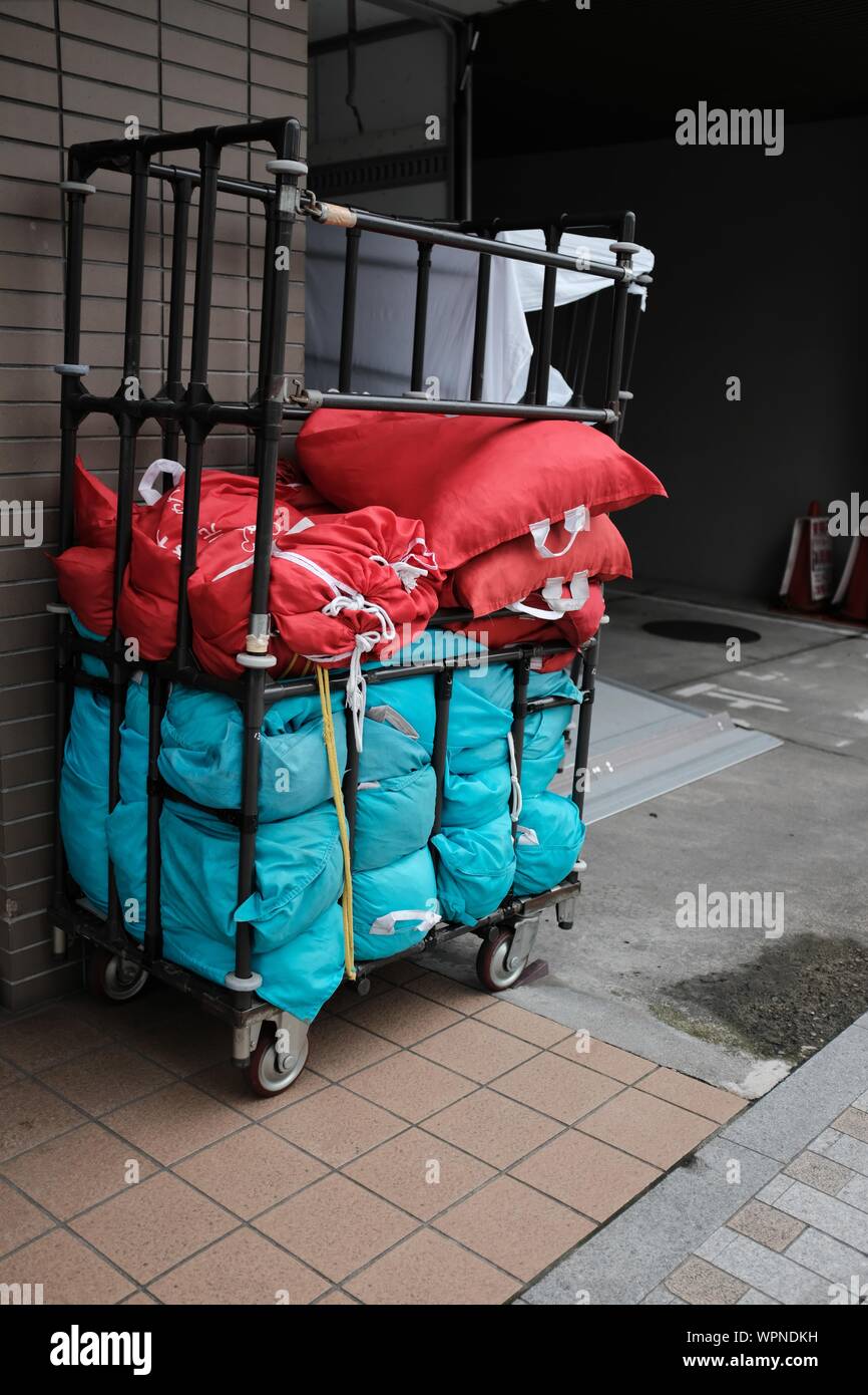 Vertical shot of red and blue sacks stacked on a rack Stock Photo - Alamy
