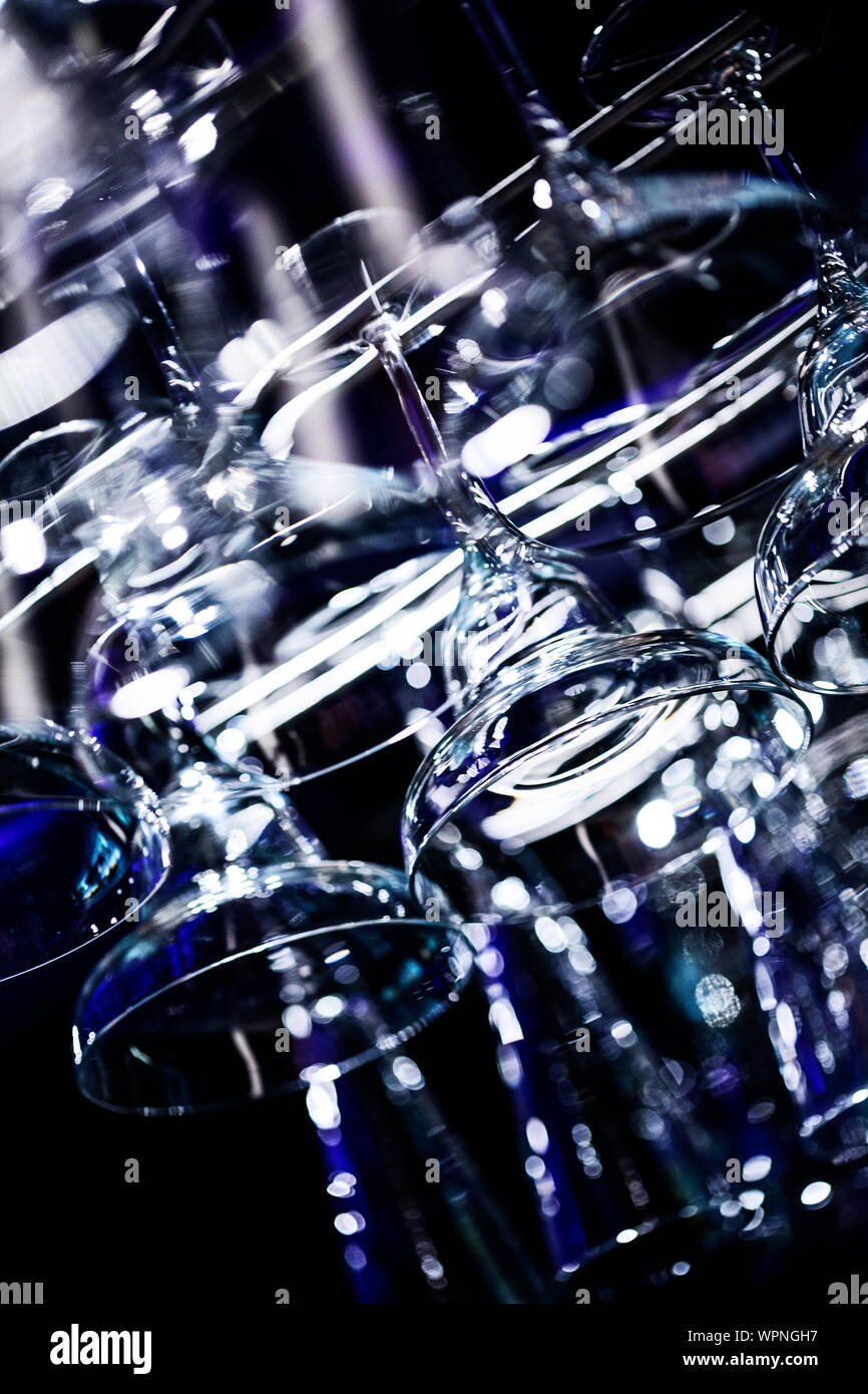 Glass cups hanging from bar ceiling Stock Photo - Alamy