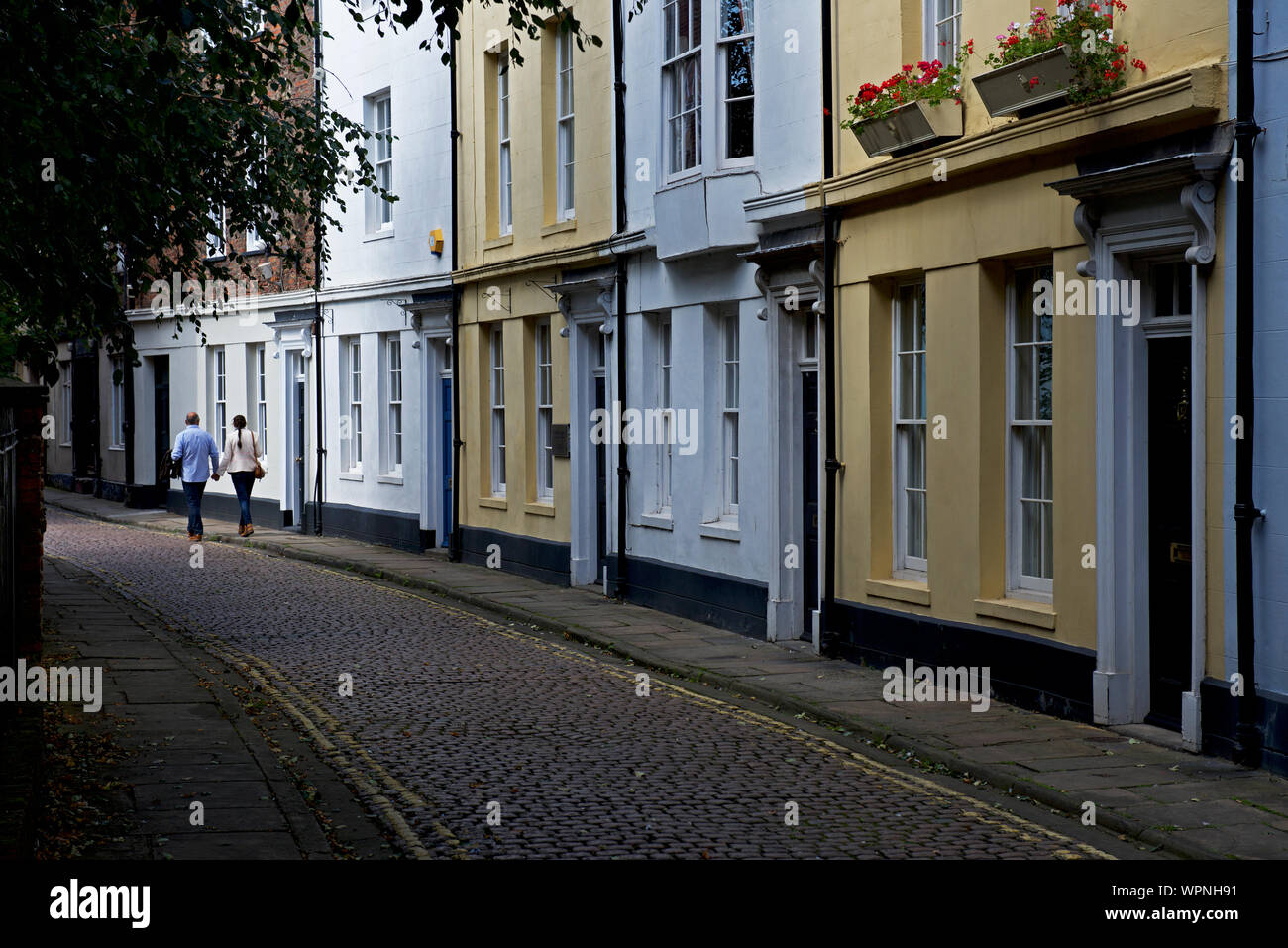 Couple walking past the Georgian Houses on cobbled Prince Street, Hull ...