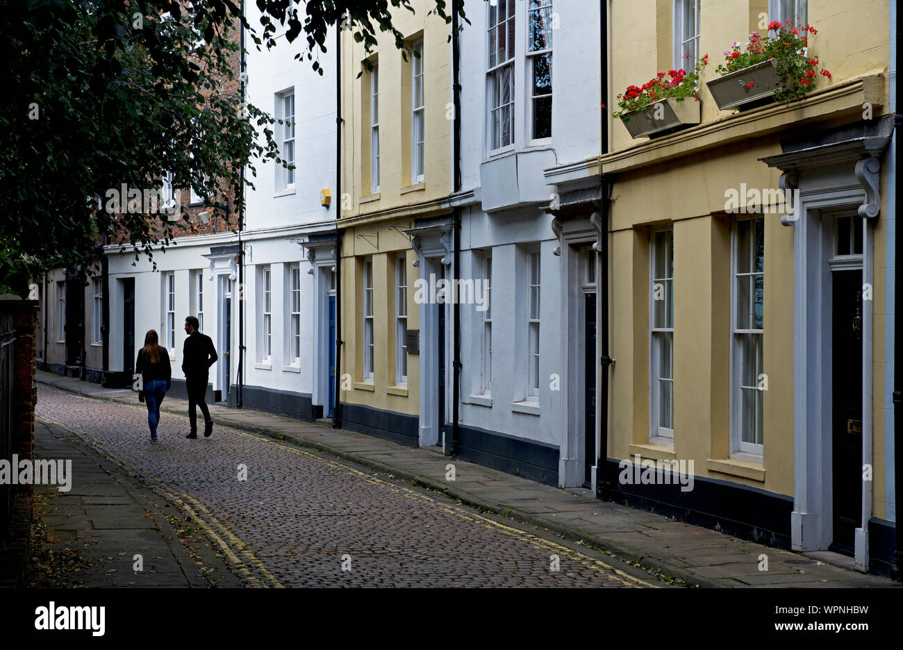 Couple walking past the Georgian Houses on cobbled Prince Street, Hull ...