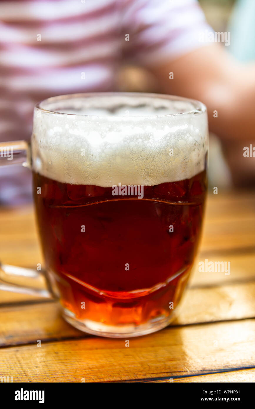 Man is holding a freshly tapped glass of cold beer in his hand Stock ...