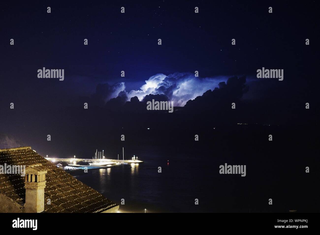 Illuminated Pier At Night Stock Photo - Alamy