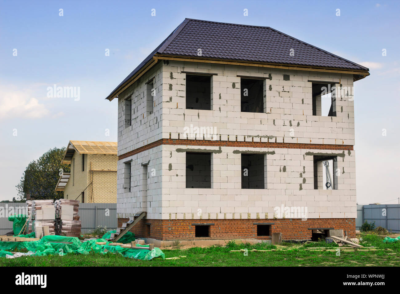 Under construction house of aerated concrete blocks, roof already made ...