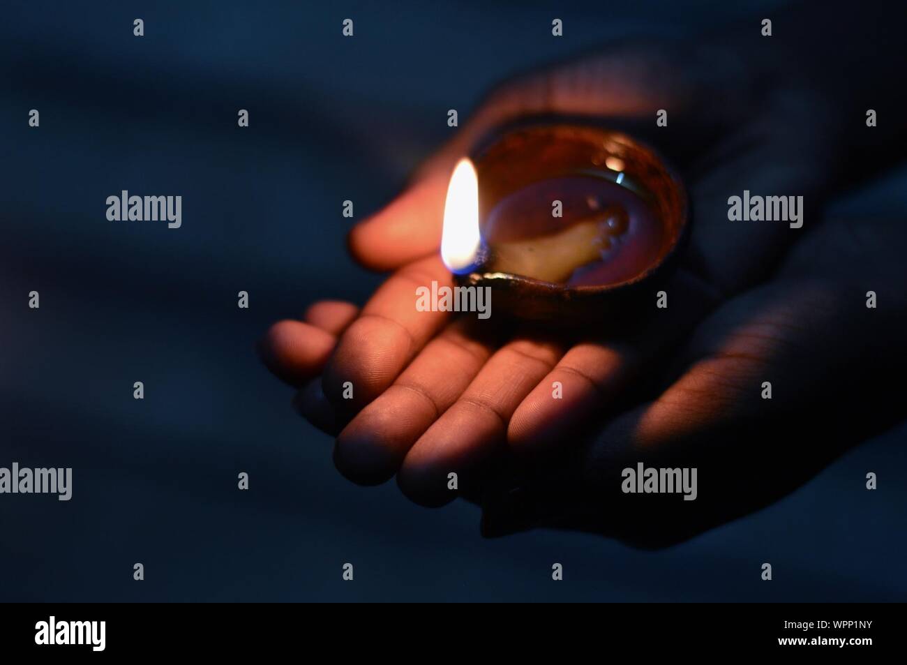 Hand holding diya hi-res stock photography and images - Alamy
