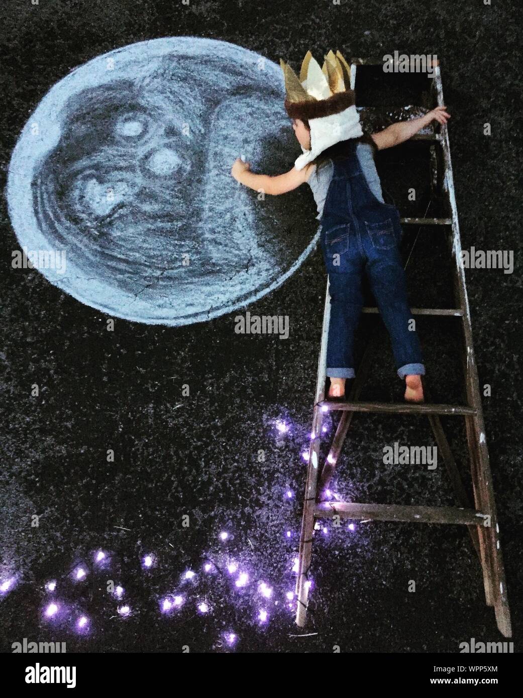 Girl on ladder hi-res stock photography and images - Alamy