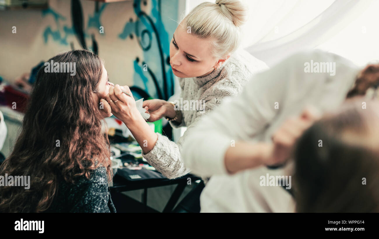 professional makeup artist doing makeup for client's salon Stock Photo ...