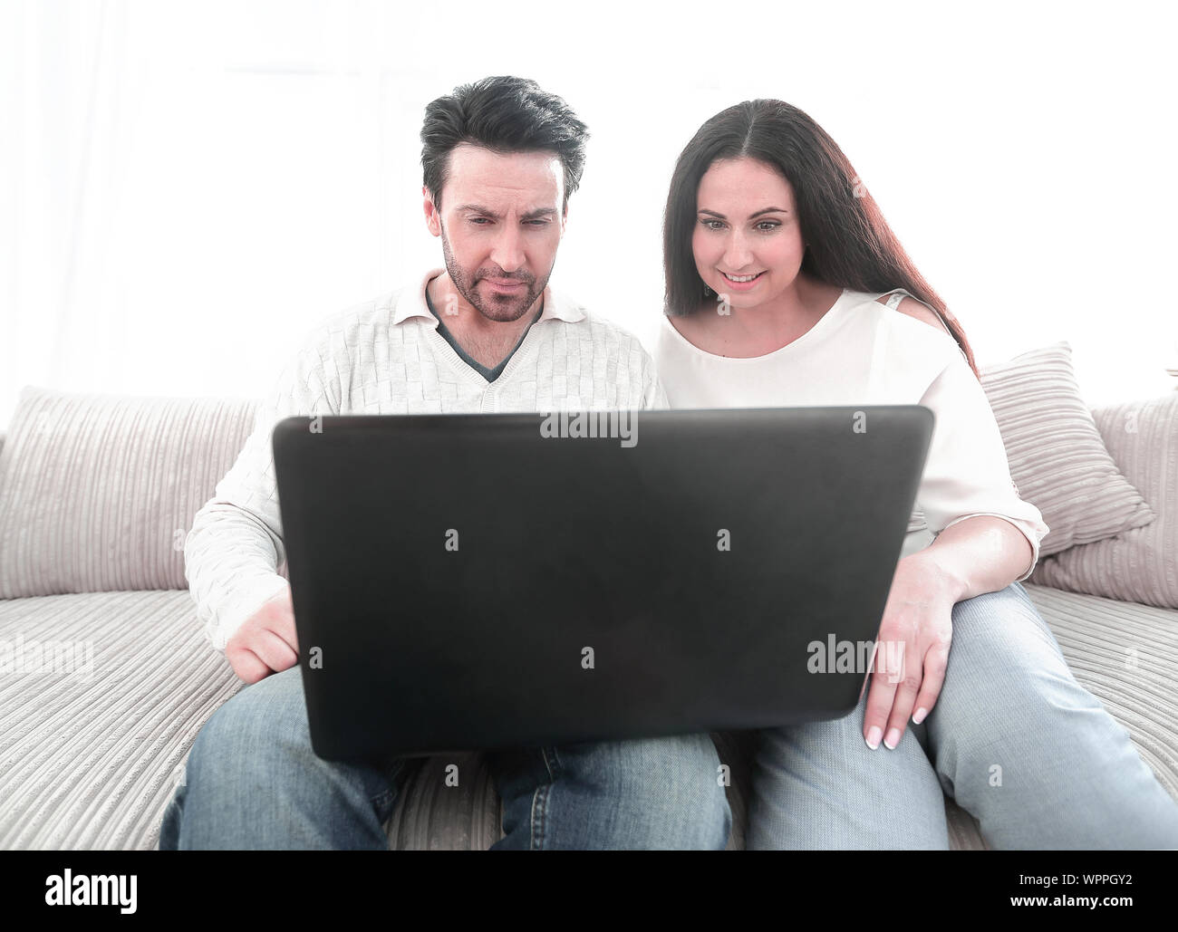 married couple watching a show on their laptop .photo with copy space ...