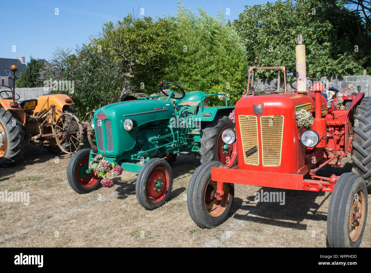 3 old colourful tractors Stock Photo - Alamy
