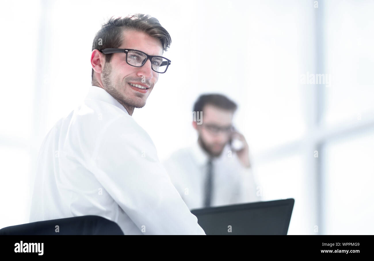 rear view.employees sitting at the office Desk.business background ...