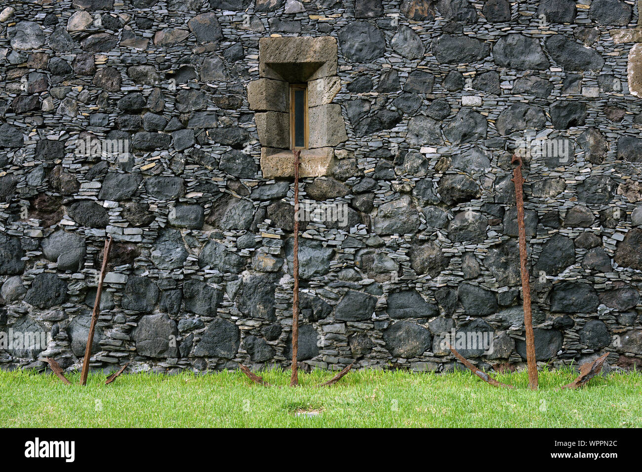 Rusty Anchors Leaning On Stone Wall Stock Photo - Alamy