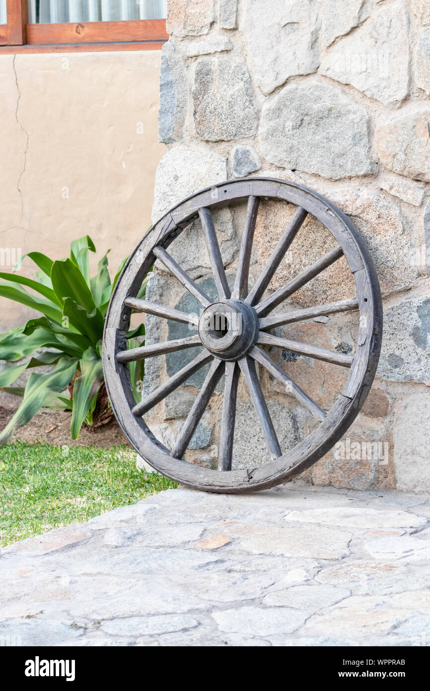 Old carriage wheel used as decoration in a house Stock Photo - Alamy