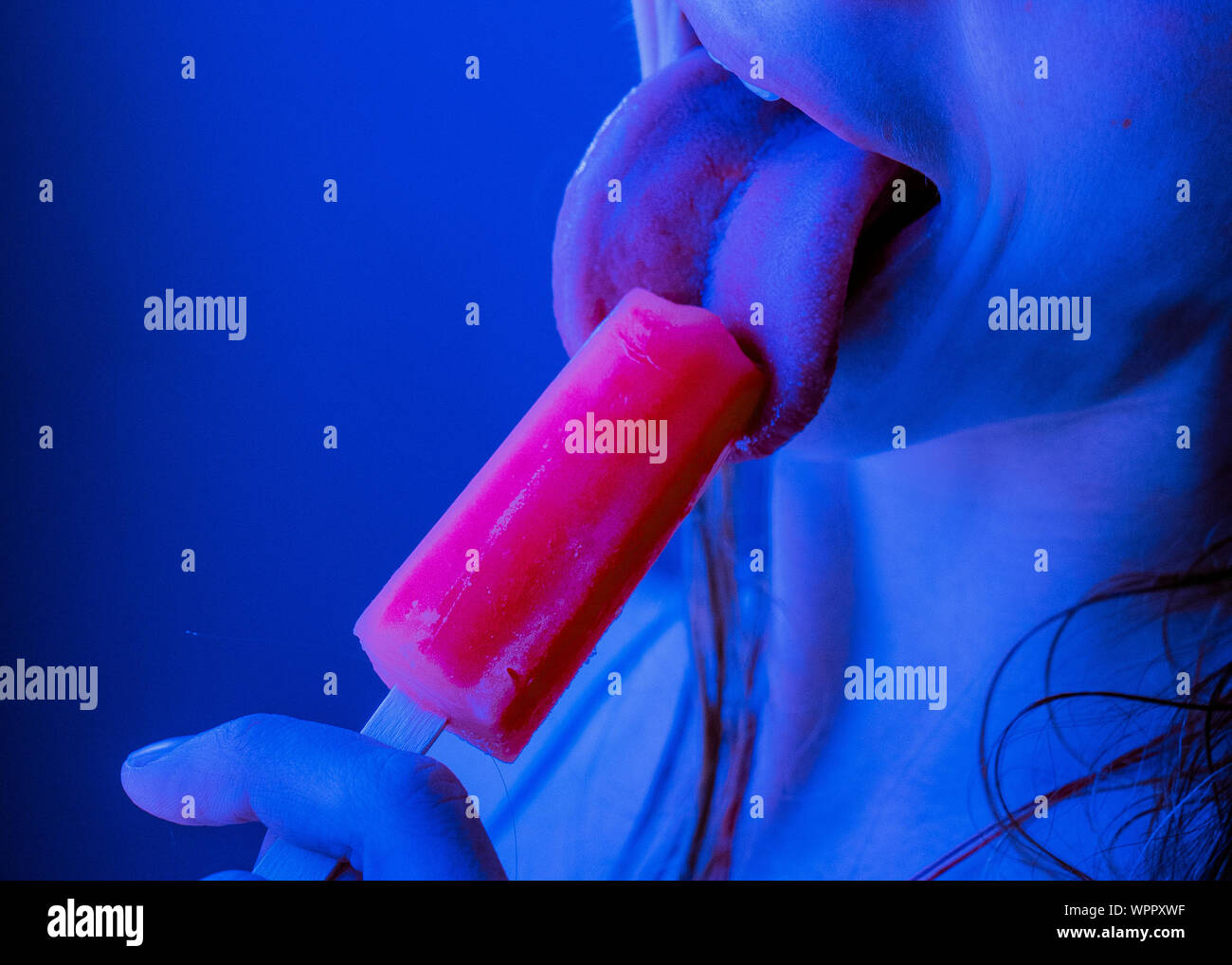 Woman licking popsicle hi-res stock photography and images - Alamy