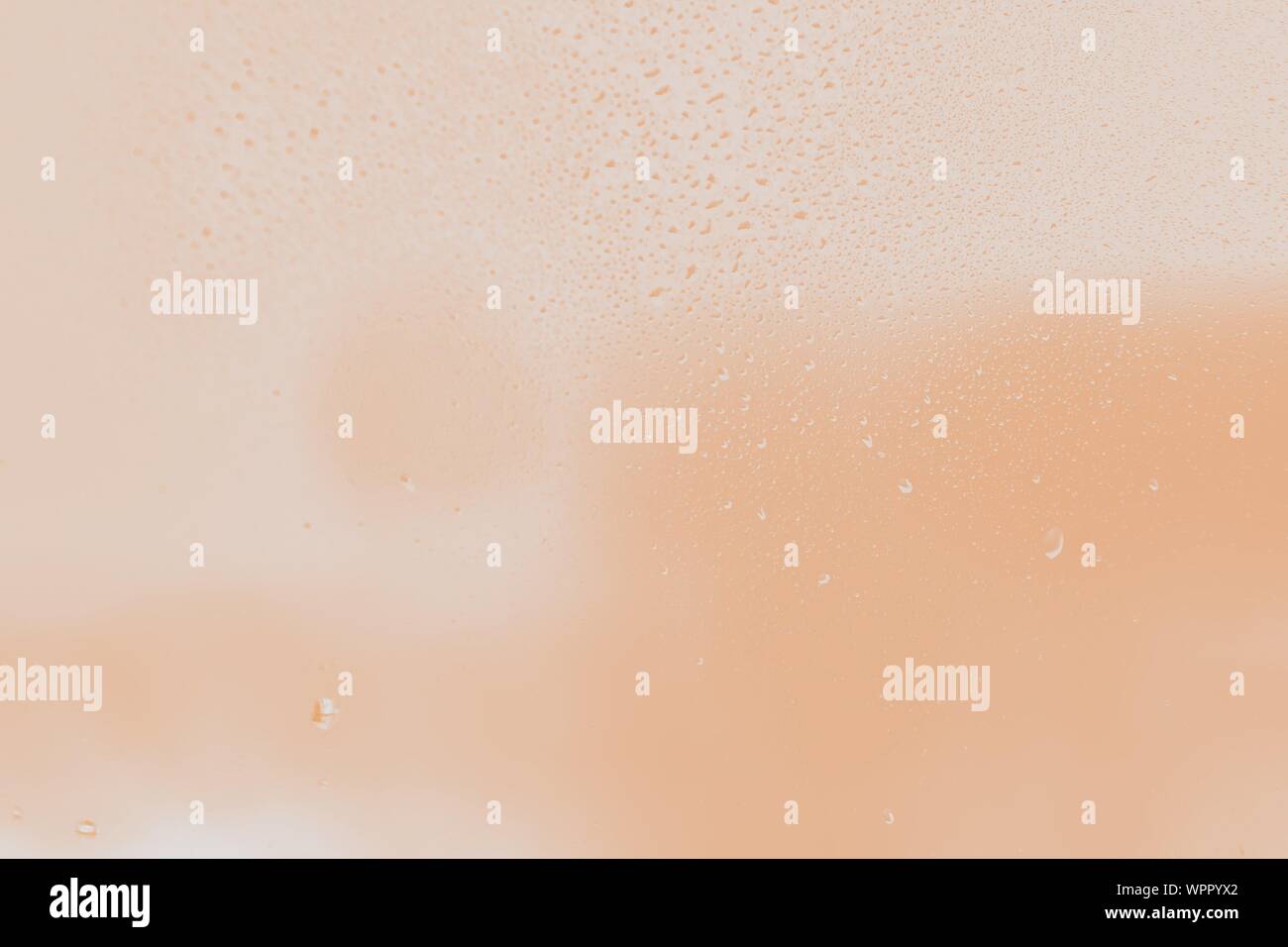 Raindrops on window glass. Peach color gradient background Stock Photo ...