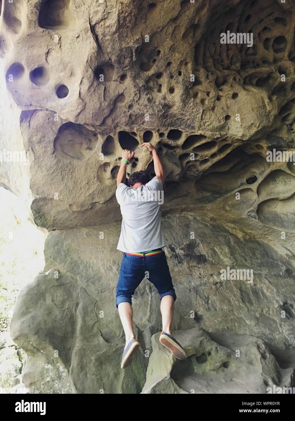 Man hanging on cliff hi-res stock photography and images - Alamy