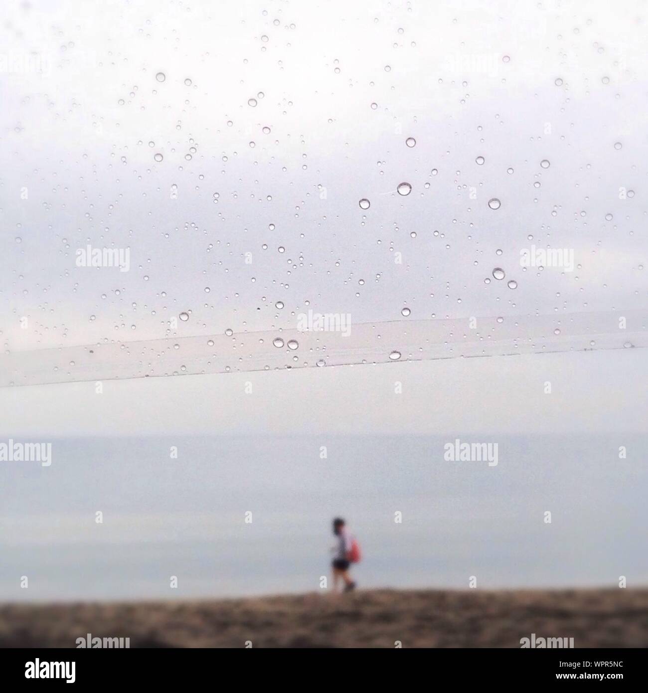 View Of Ocean Through Wet Window Stock Photo - Alamy