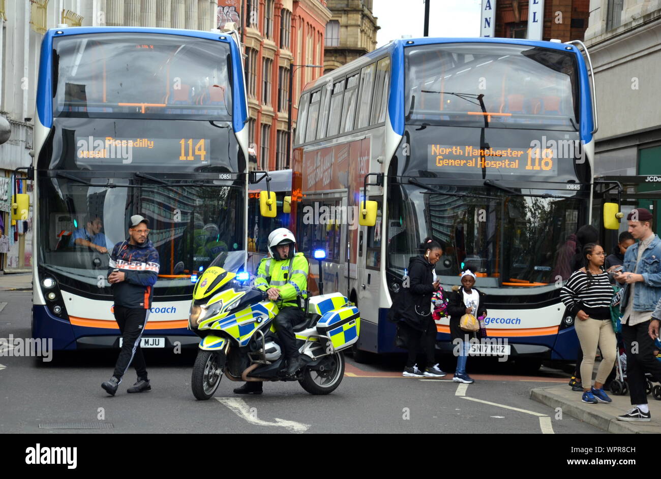 A police motorcyclist blocks traffic, including two Stagecoach buses ...