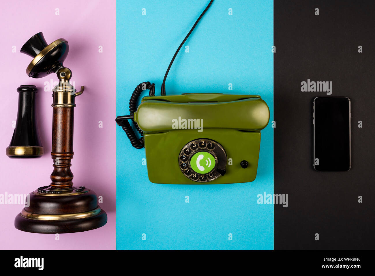 Old brown vintage telephone along with a wired green telephone and ...