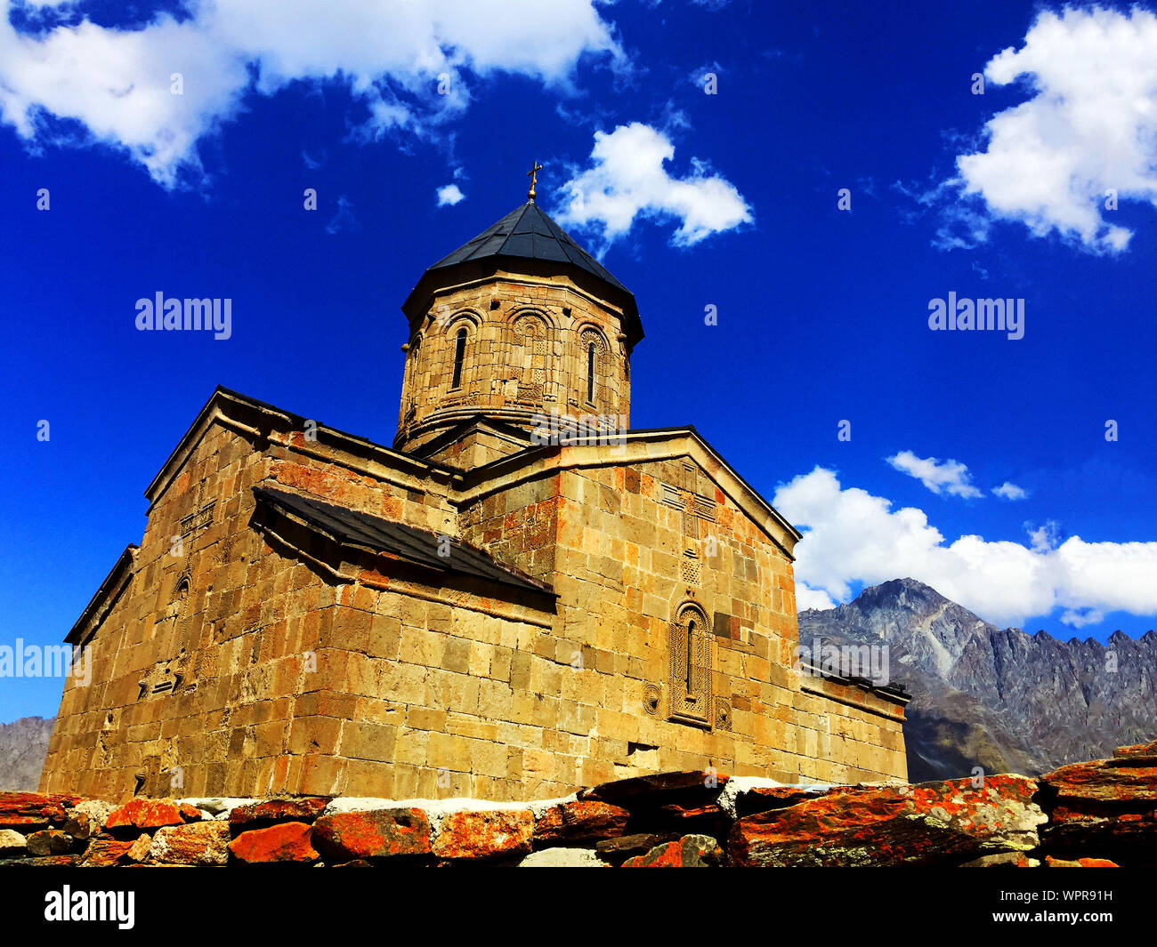 Medieval Church of the assumption on Kazbek mountain. Famous Gergeti ...