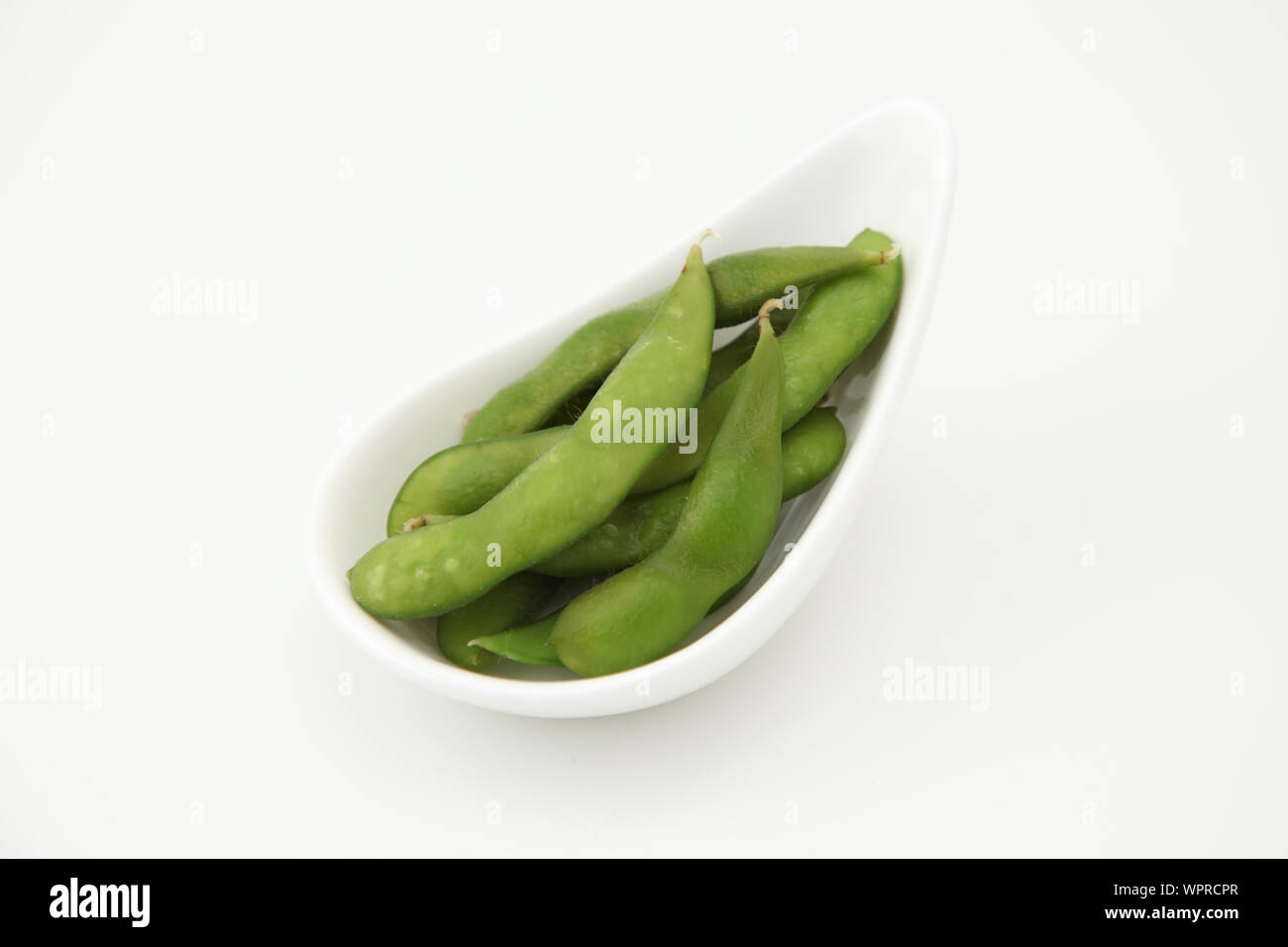 Green soybeans edamame japanese snack on plate isolated on white ...