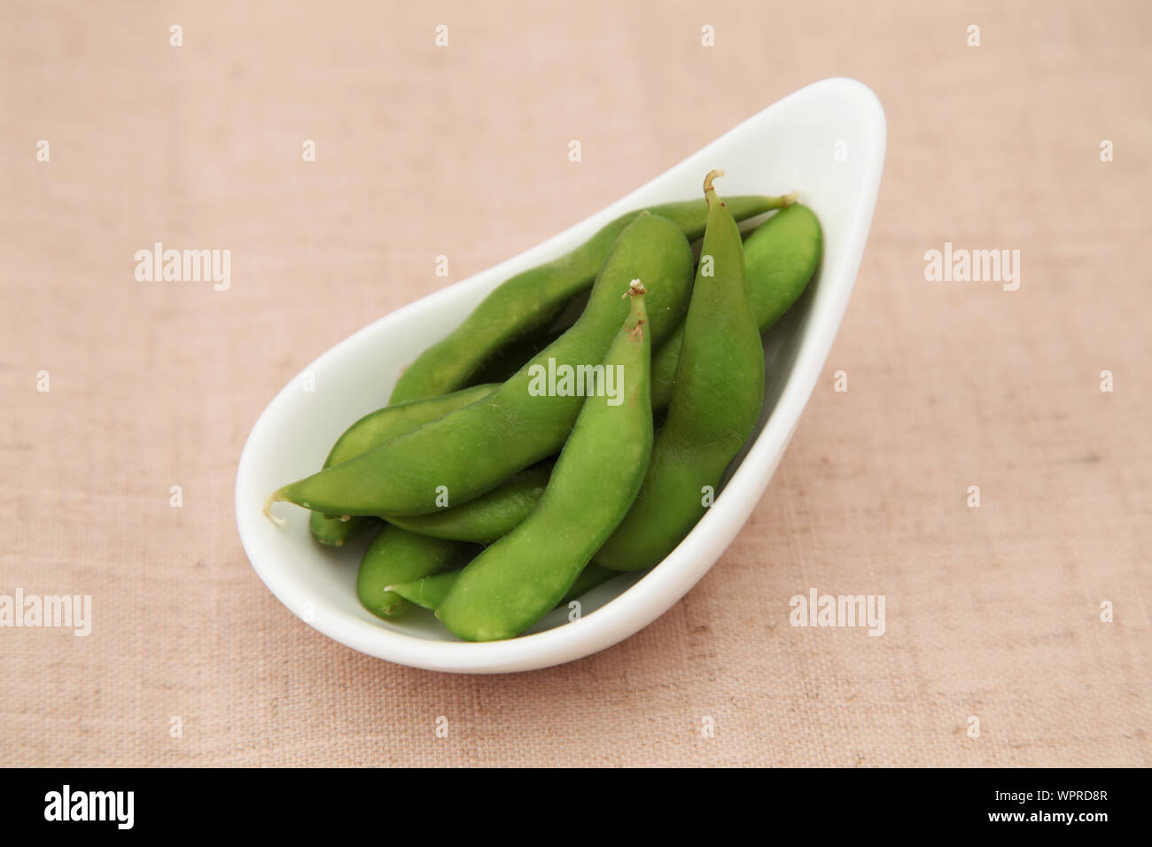 Green soybeans edamame japanese snack on plate isolated on table Stock ...