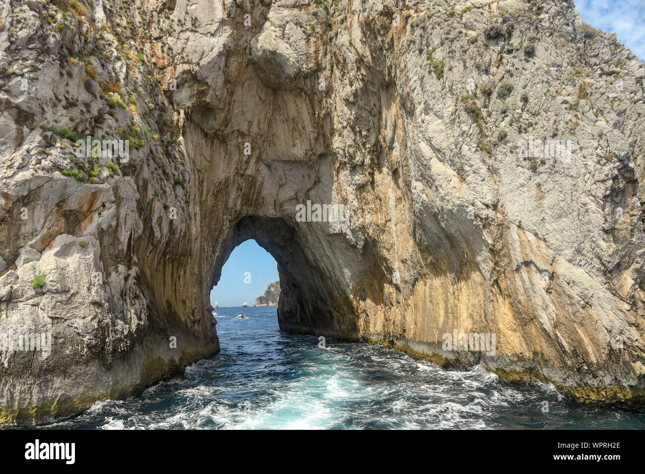 ISLE OF CAPRI, ITALY - AUGUST 2019: The arched tunnel in the Faraglioni ...