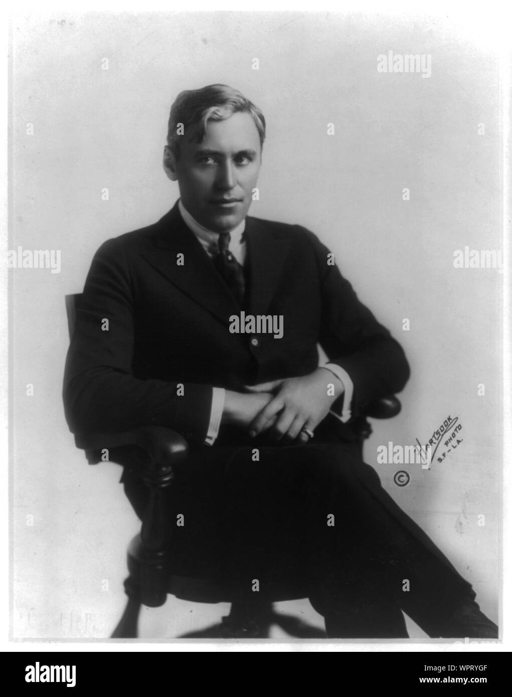 Mack Sennett, 1880-1960, three-quarters length, seated in chair, facing ...