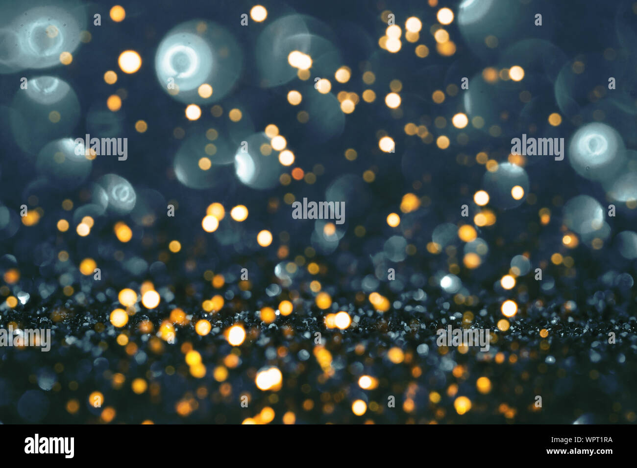 Blue and gold festive background with sparkles in the bokeh. The ...