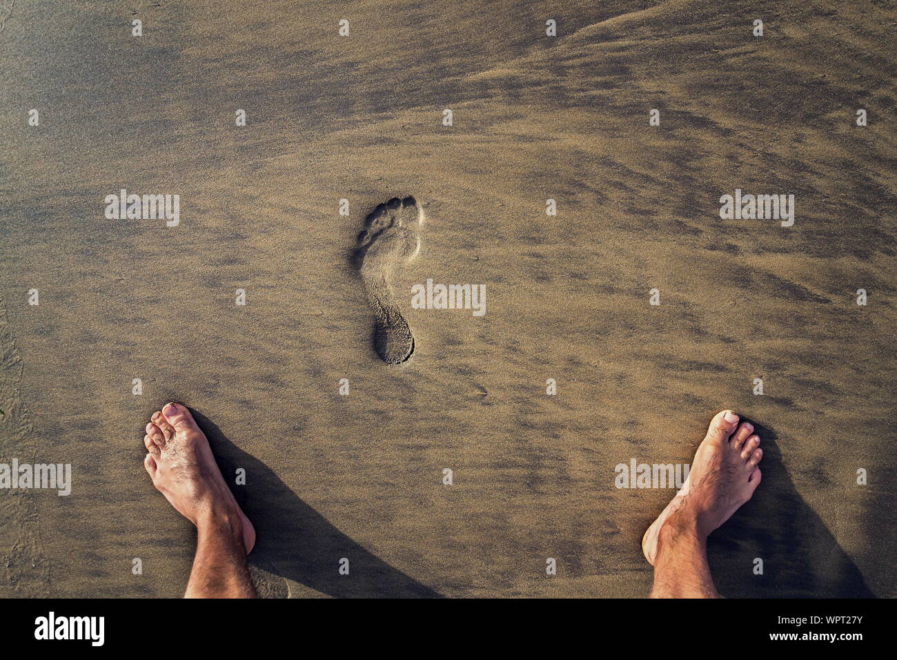 Human footprint with barefoot feet in brown yellow sand beach ...