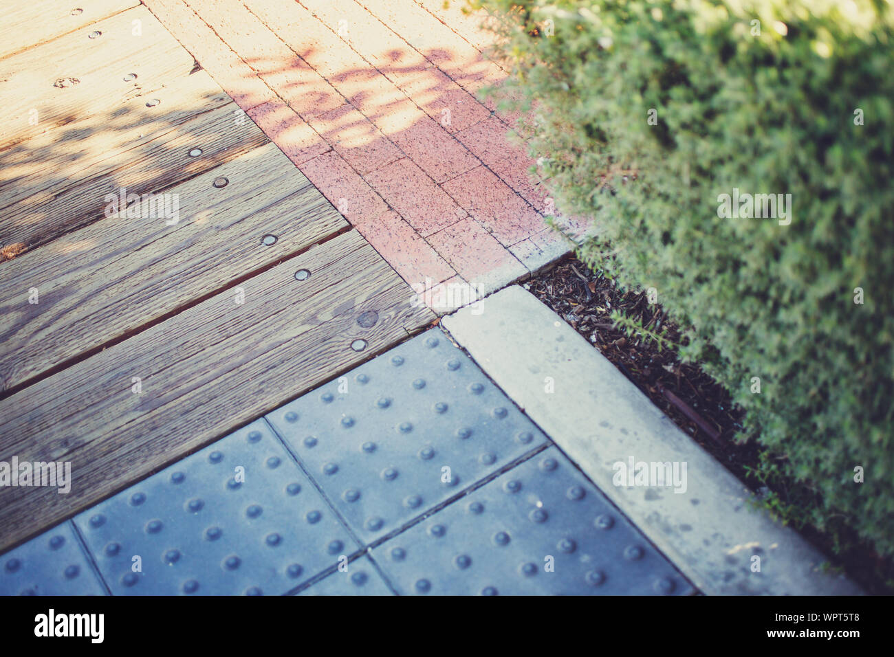 A view looking down at a corner of four different floor textures and ...