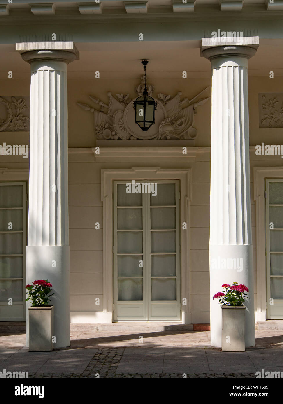 Part of the facade of a neoclassical building with columns ...