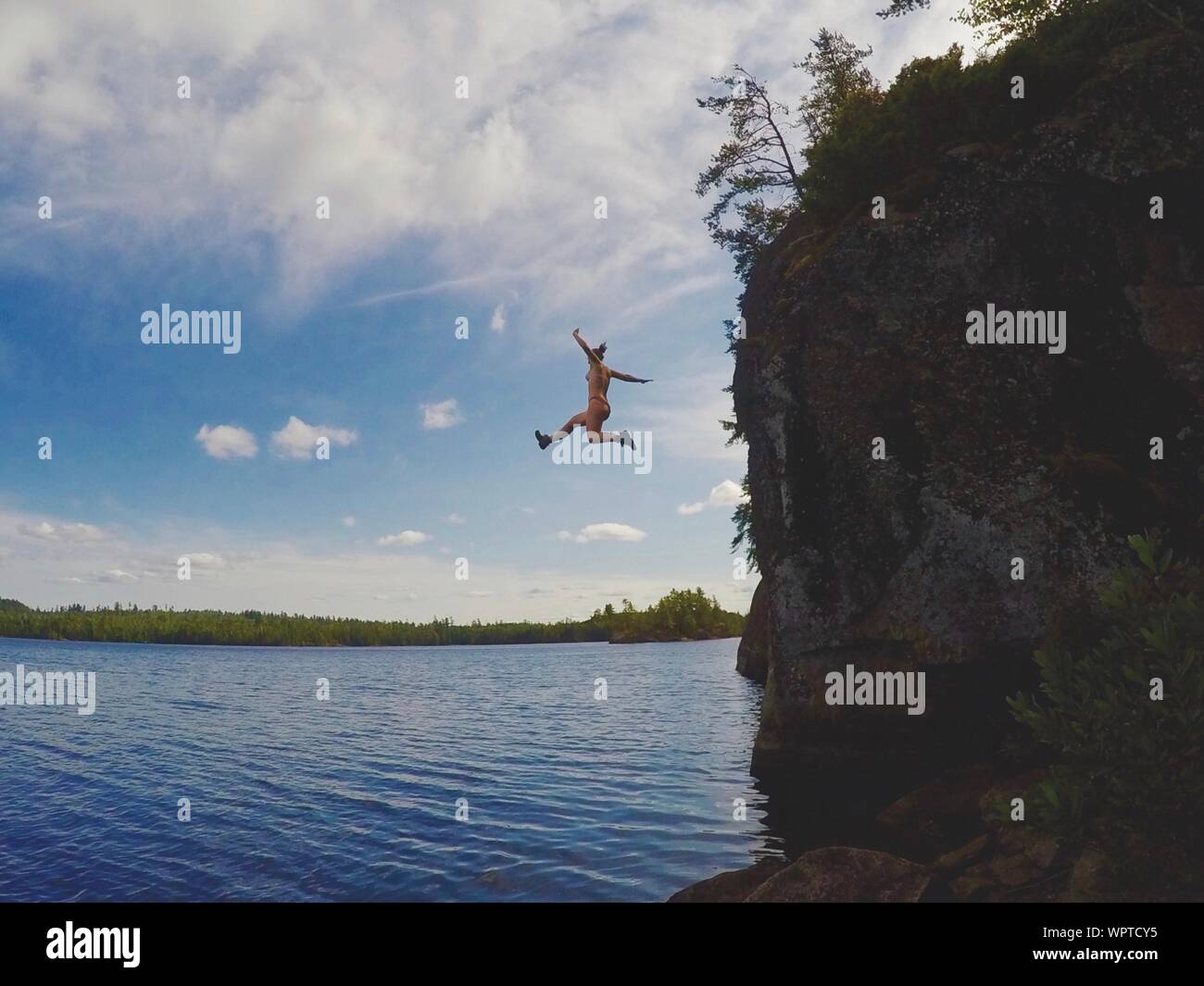Woman jumping rock formation hi-res stock photography and images - Alamy