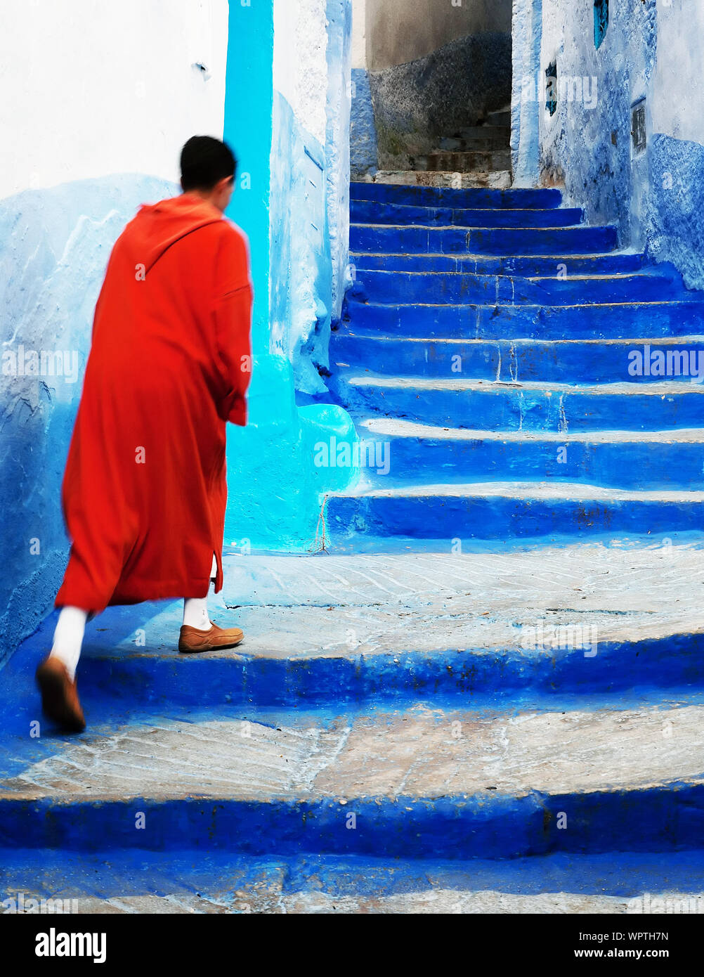 Rear View Of Man Moving Up On Steps By Houses Stock Photo - Alamy