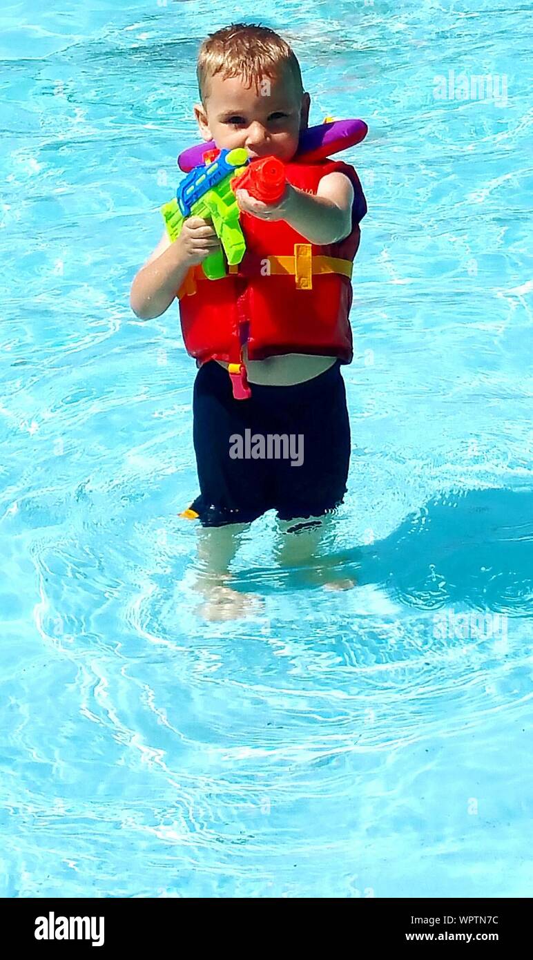 Boy Wearing Life Jacket Holding Stock Photos & Boy Wearing Life Jacket ...