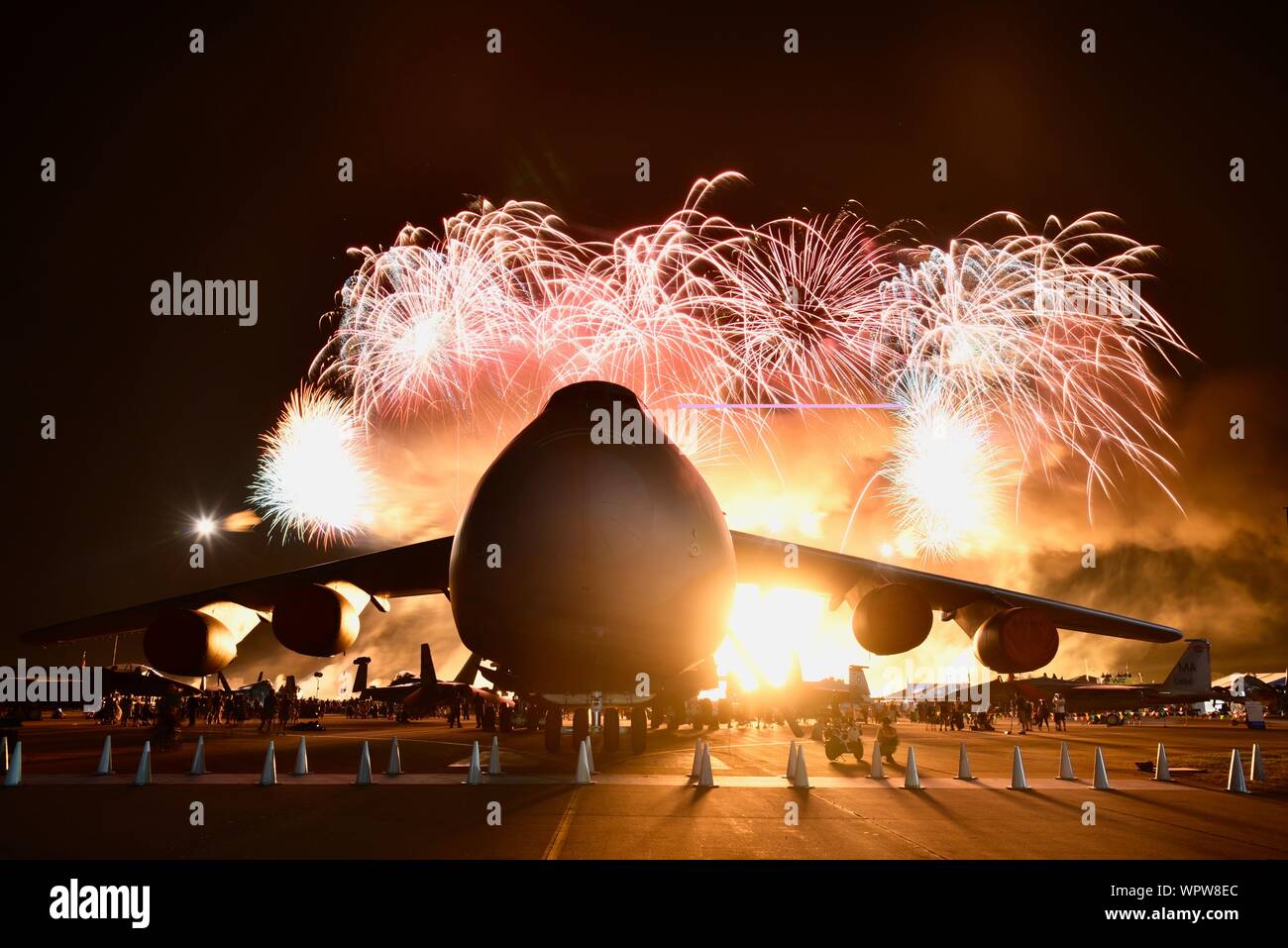 Spectacular fireworks explode behind massive Lockheed C-5M Super Galaxy ...