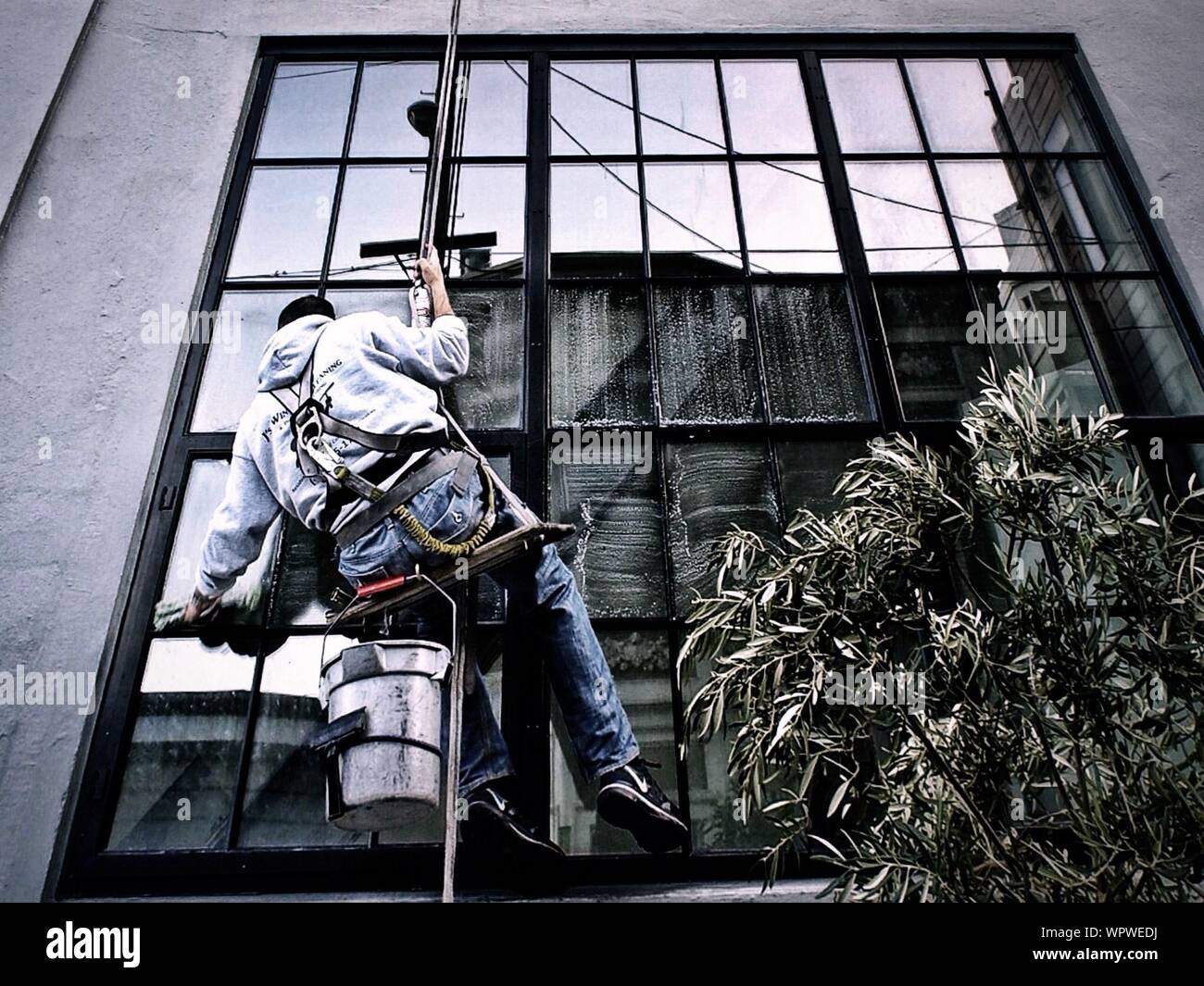 Hanging from window worker hi-res stock photography and images - Alamy