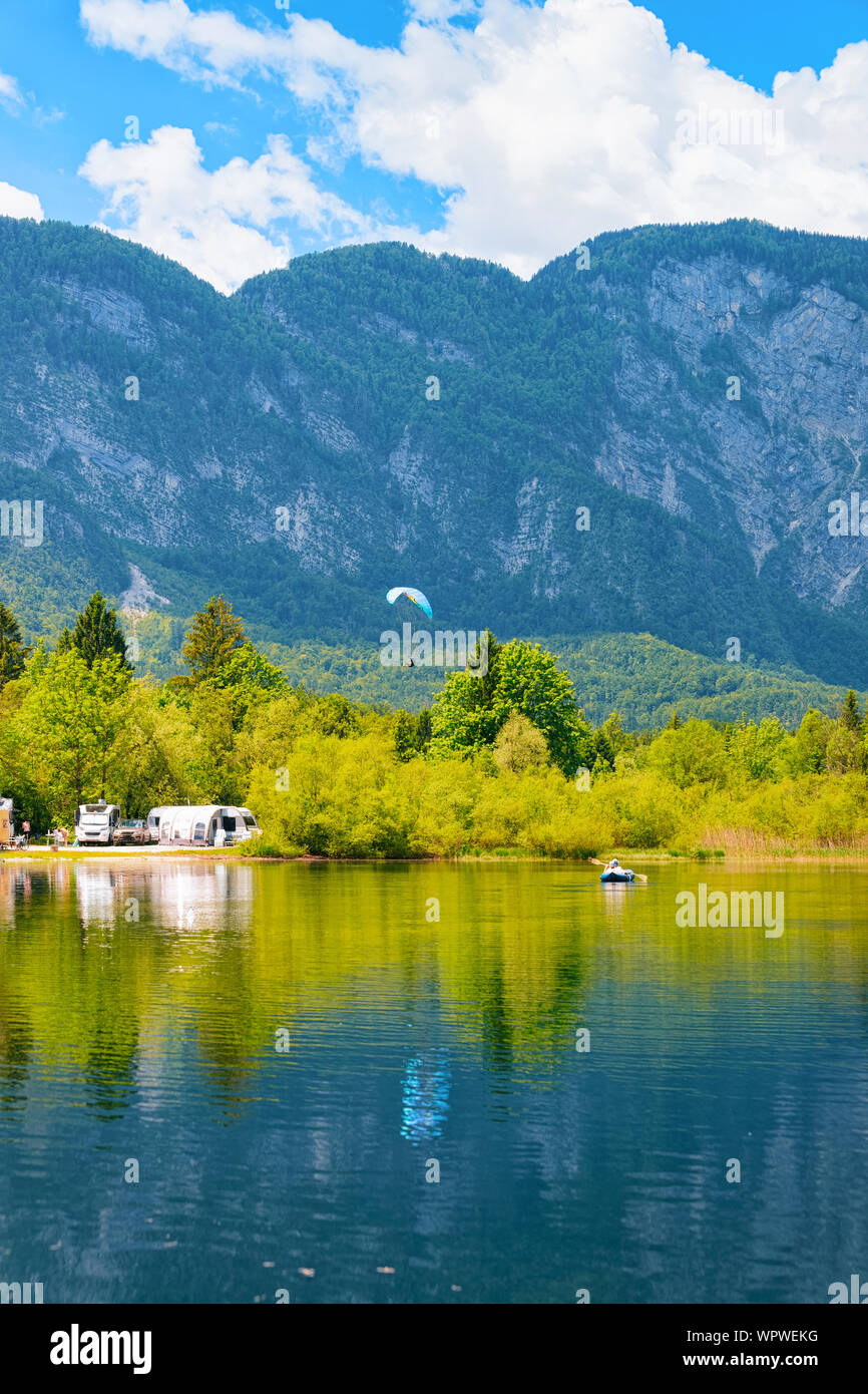 Camping of RV caravan trailers paragliding and canoe Bohinj Lake Stock ...