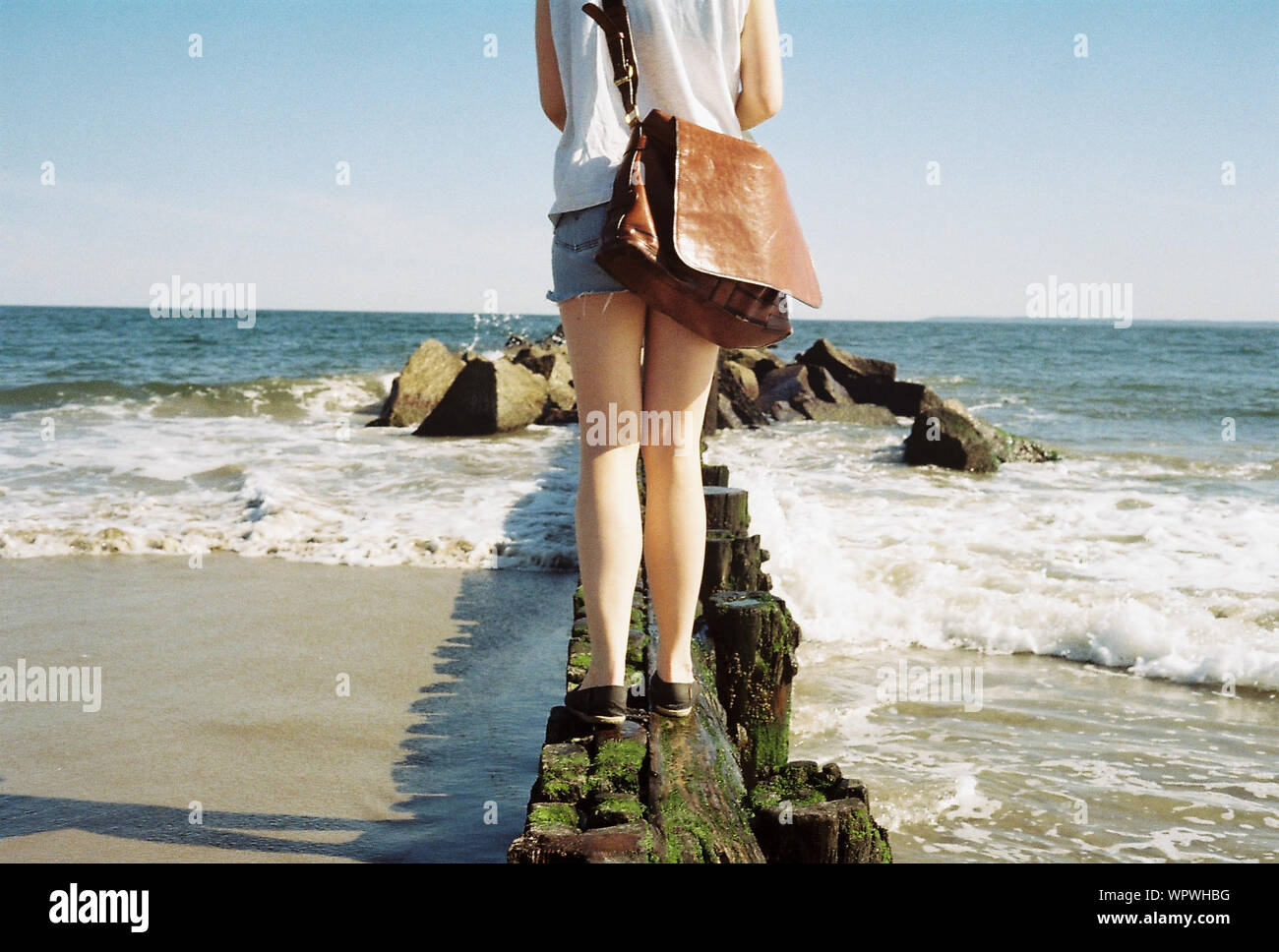 Woman rocks beach hi-res stock photography and images - Alamy