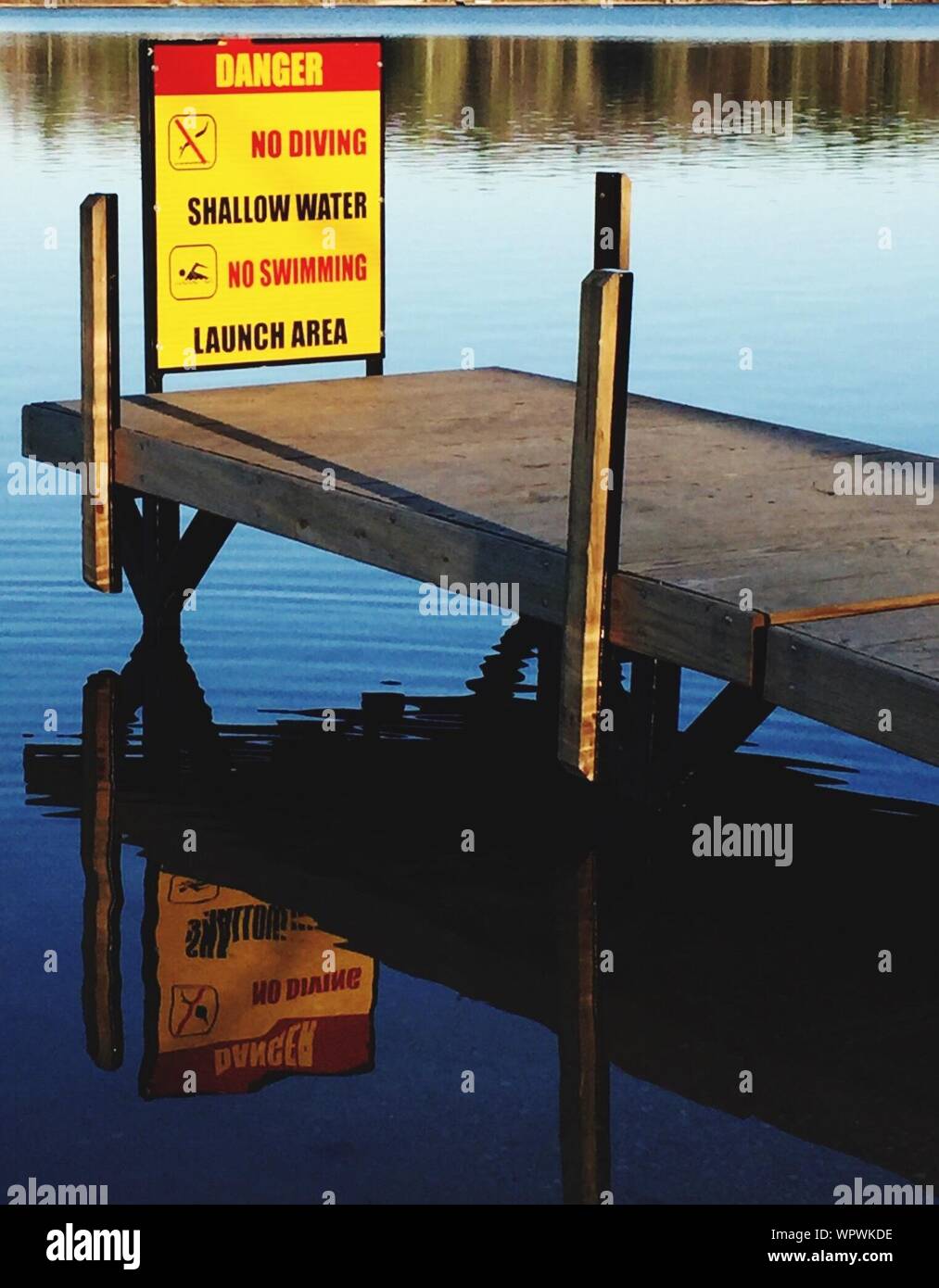 Warning Sign On Jetty Over River Stock Photo - Alamy