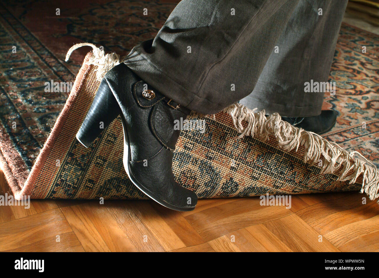 Domestic accidents, stumble in a carpet Stock Photo - Alamy