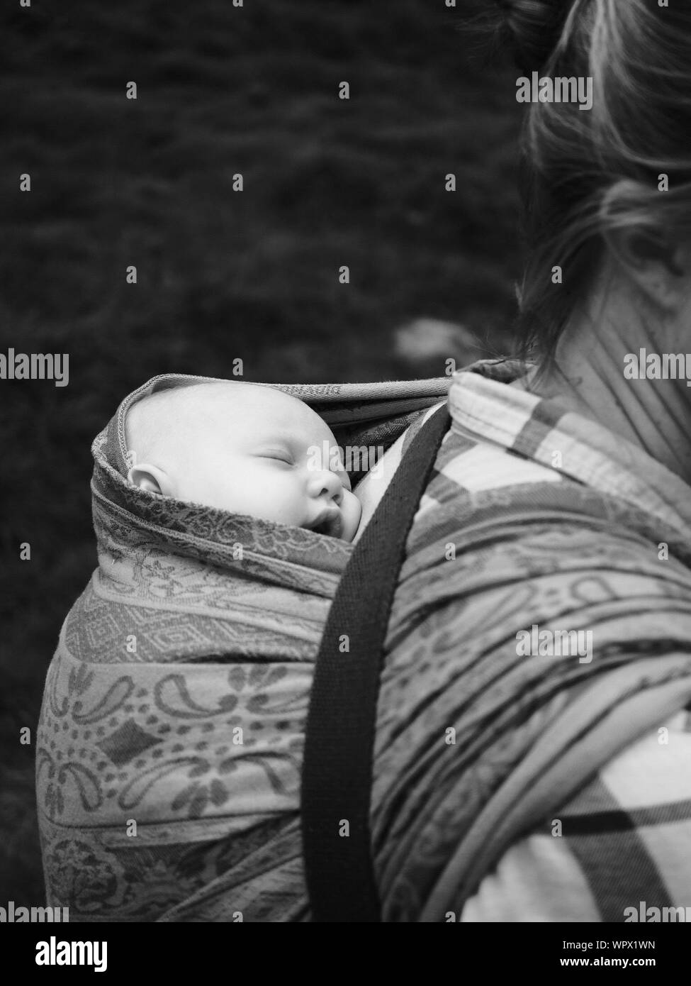 Woman carrying sleeping child Black and White Stock Photos & Images - Alamy