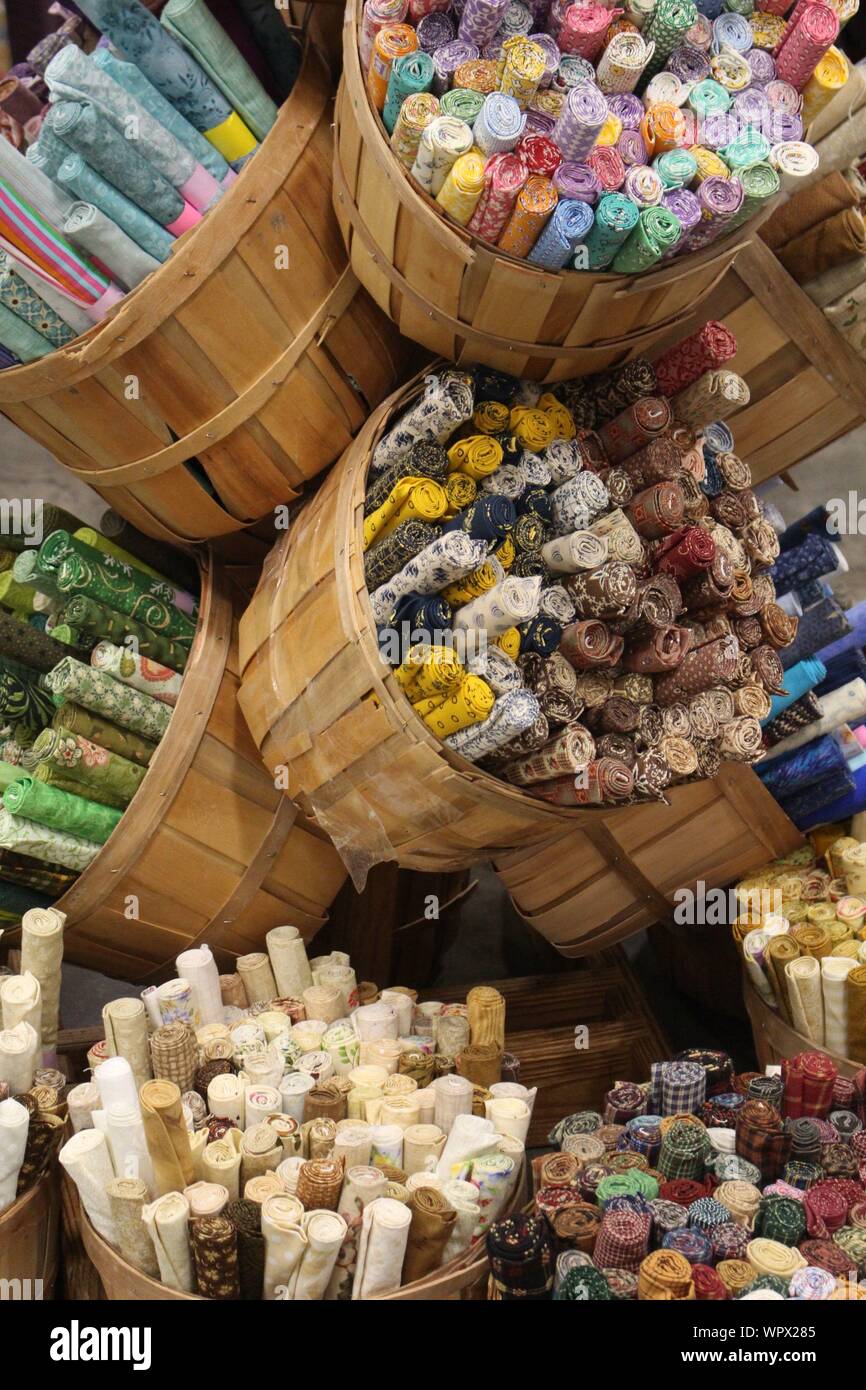 rolled fabric on display in baskets Stock Photo - Alamy