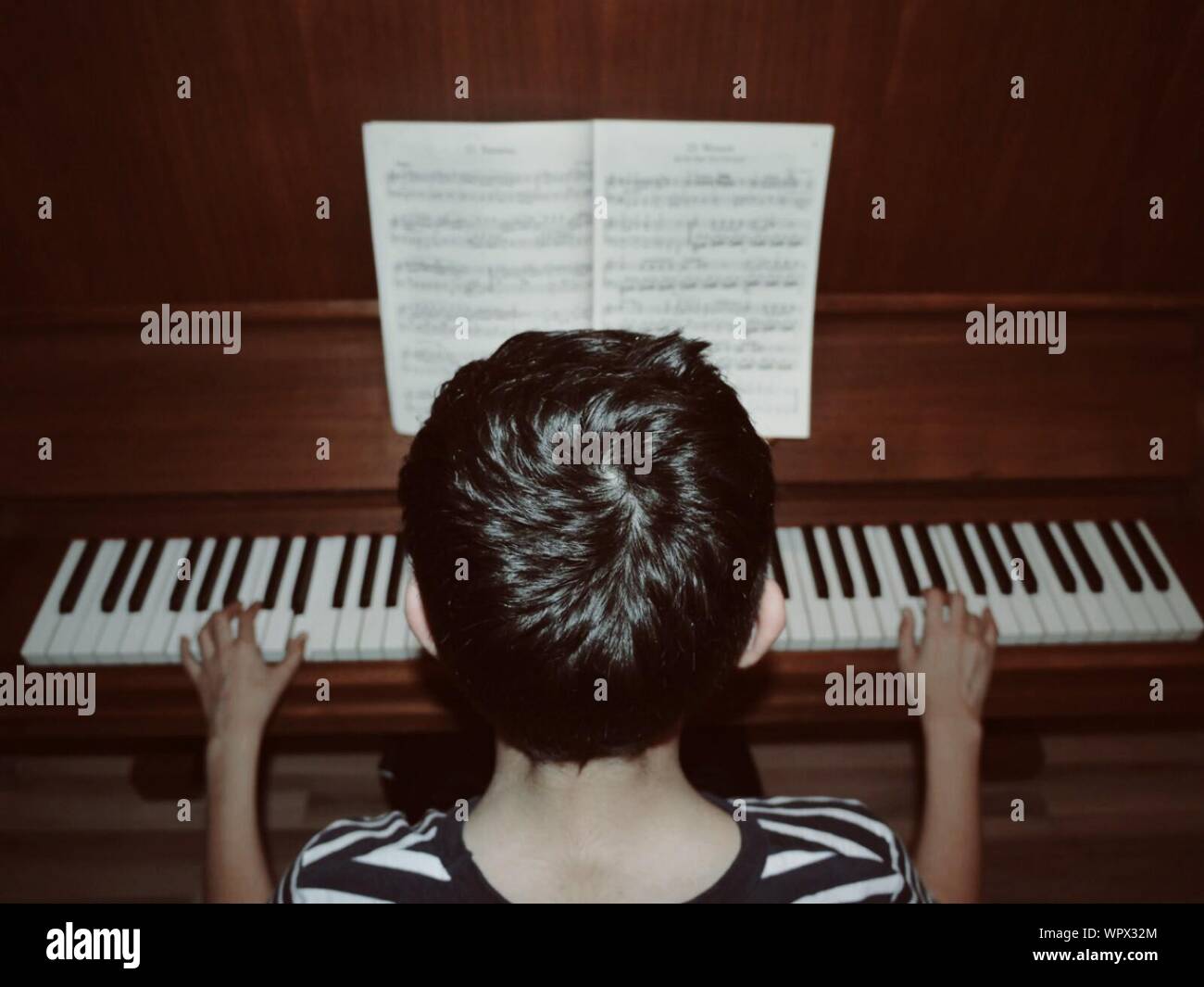 Child practicing piano hi-res stock photography and images - Alamy