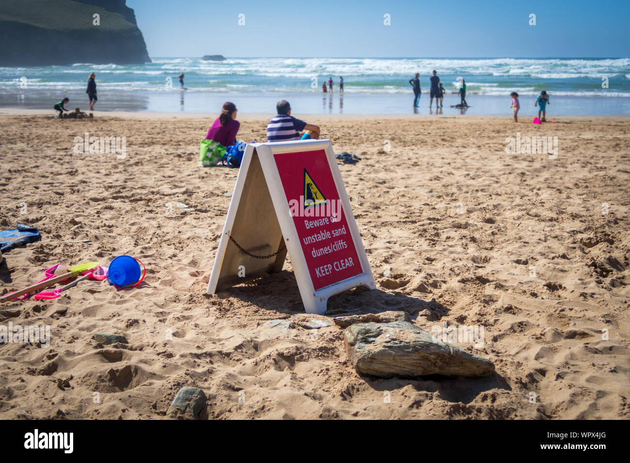 Danger sign warning beach users of potential unstable sand dunes and ...