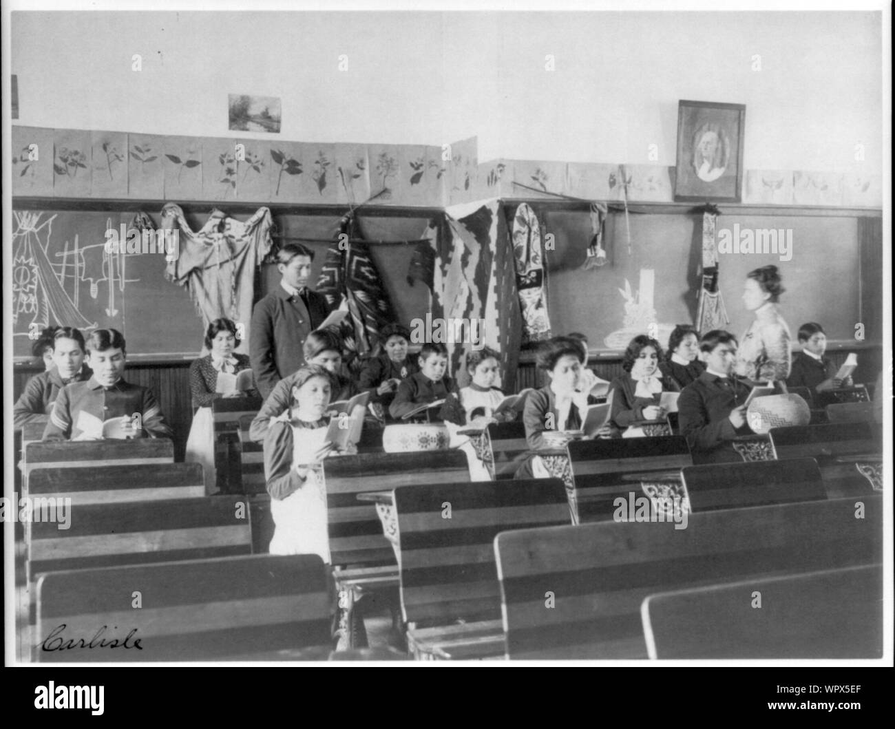 Male and female students reading in class, Carlisle Indian School ...