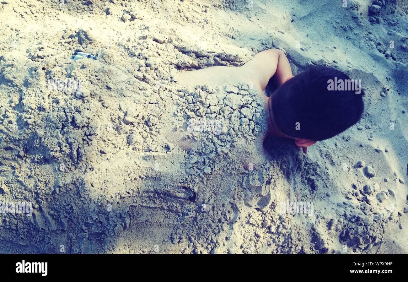 Boy Buried In Sand On High Resolution Stock Photography and Images - Alamy