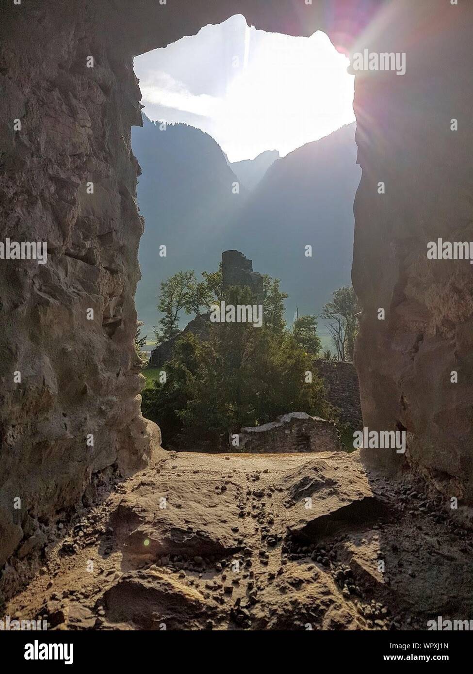 Sun shining through rock formation hi-res stock photography and images ...