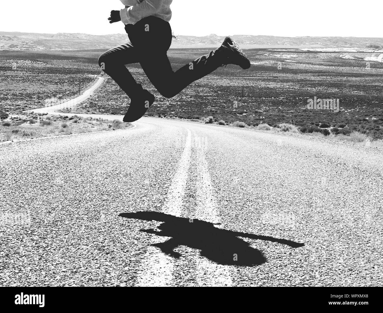 Side view man jumping in Black and White Stock Photos & Images - Alamy