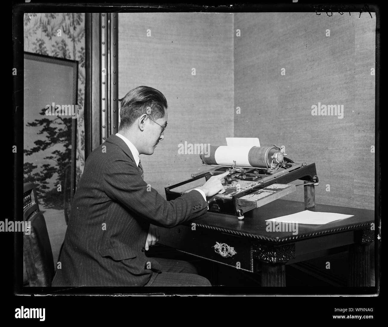 Man operating a typewriter for Japanese characters Stock Photo - Alamy